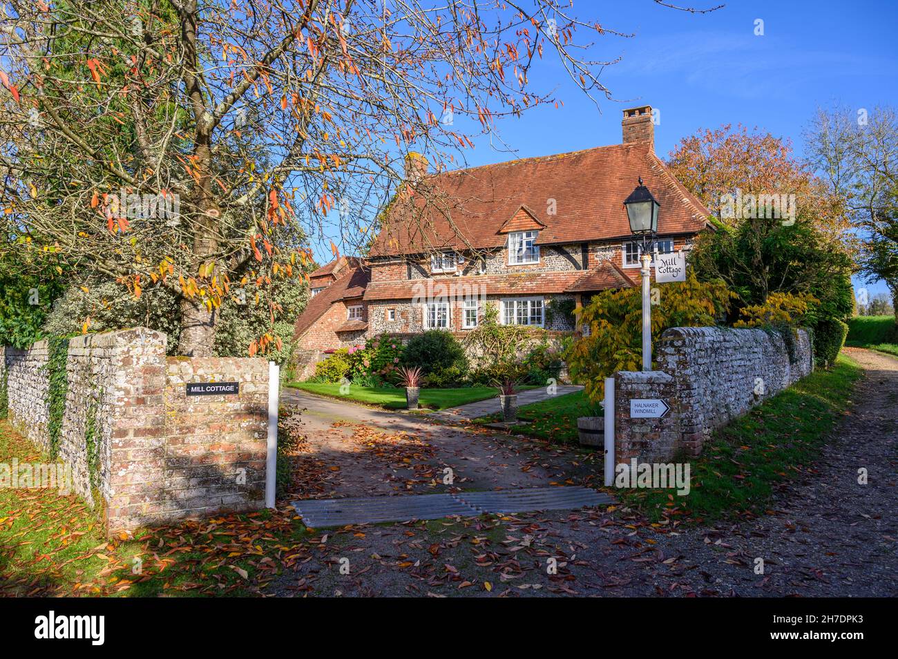 Mill Cottage, Halnaker, is an old house with brickwork and half ...