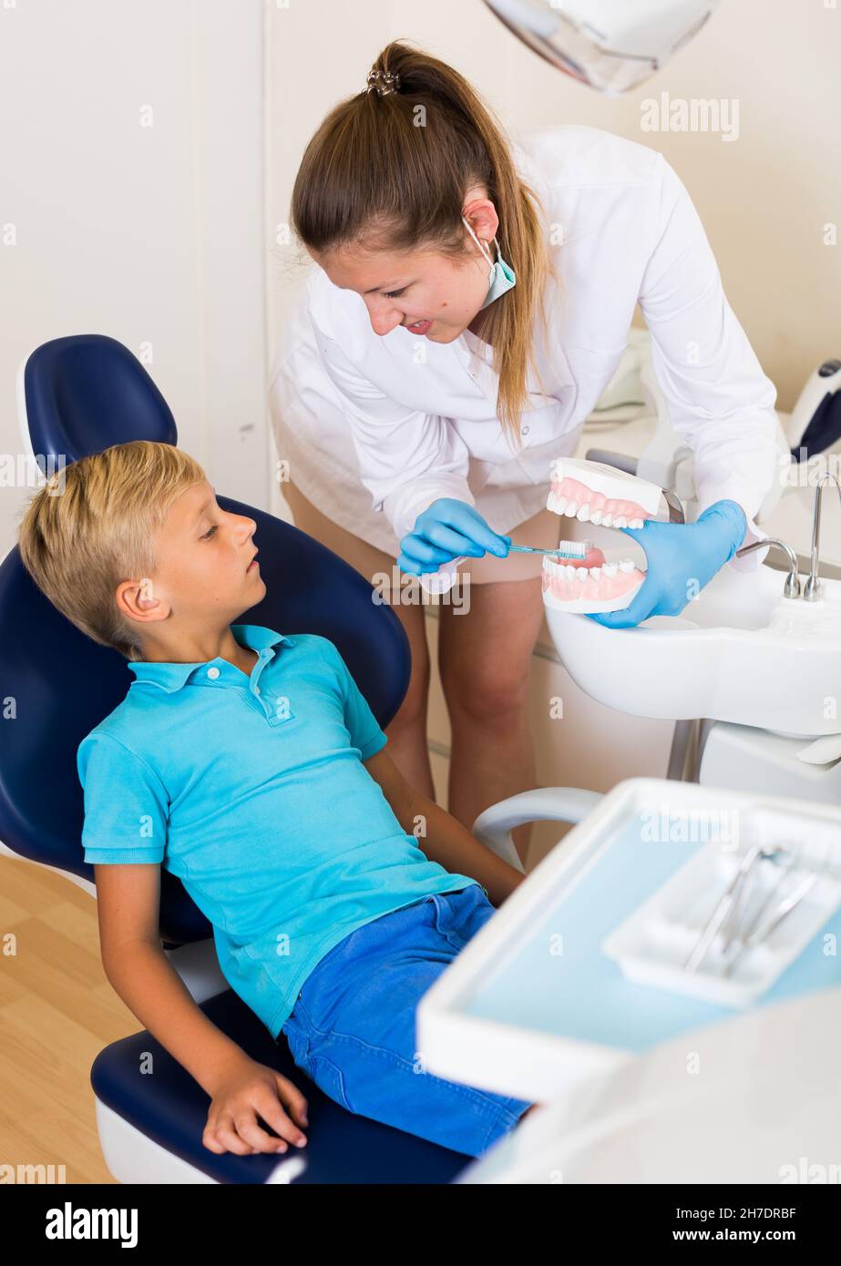 Stomatologist in uniform is telling about healthcare Stock Photo - Alamy