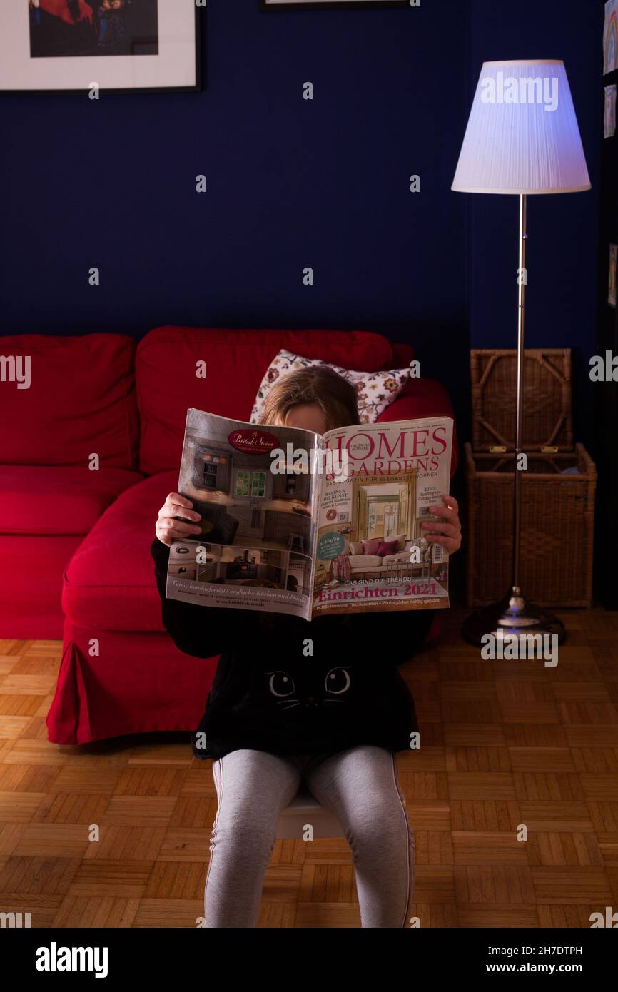 Girl reading a magazine at home Stock Photo - Alamy
