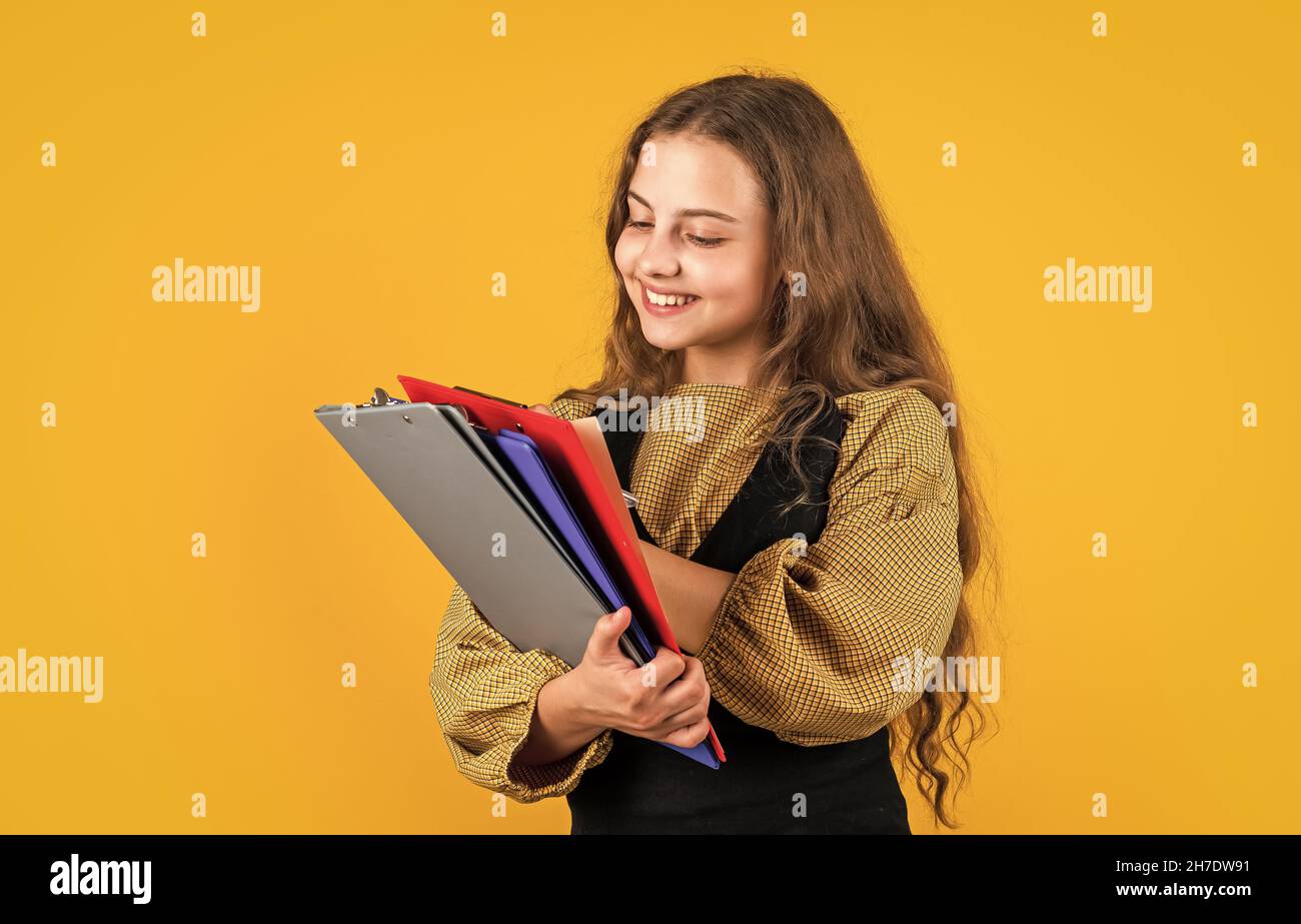 happy looking kid girl with document folder, concentrated on work Stock ...