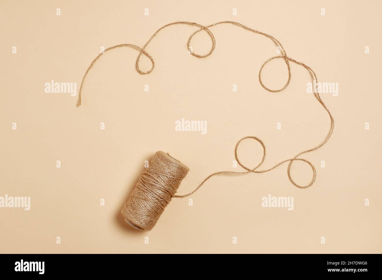 pattern of threads on beige background. Roll beige craft rope. Thread ...