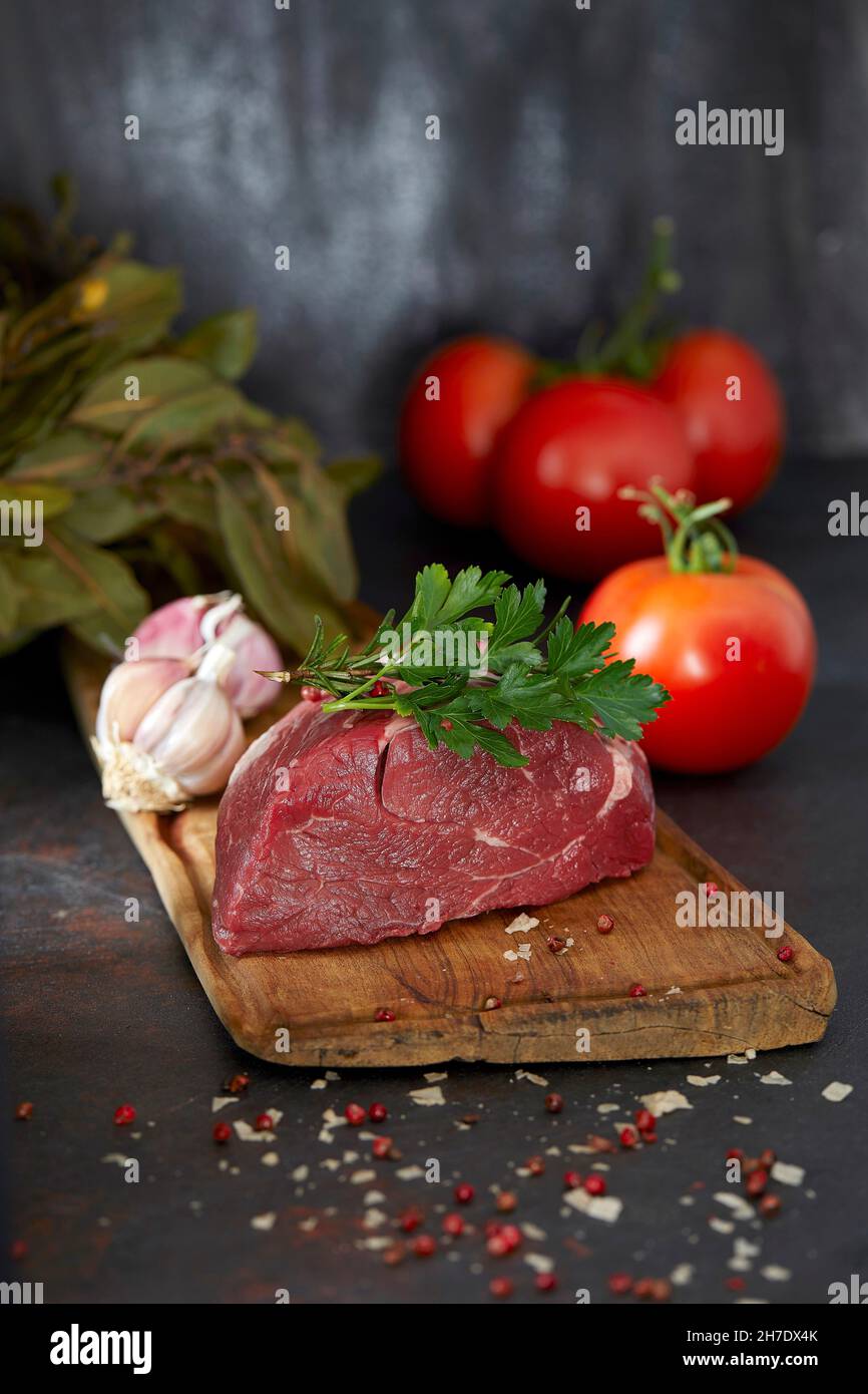 A raw beef fillet on a wooden board Stock Photo - Alamy