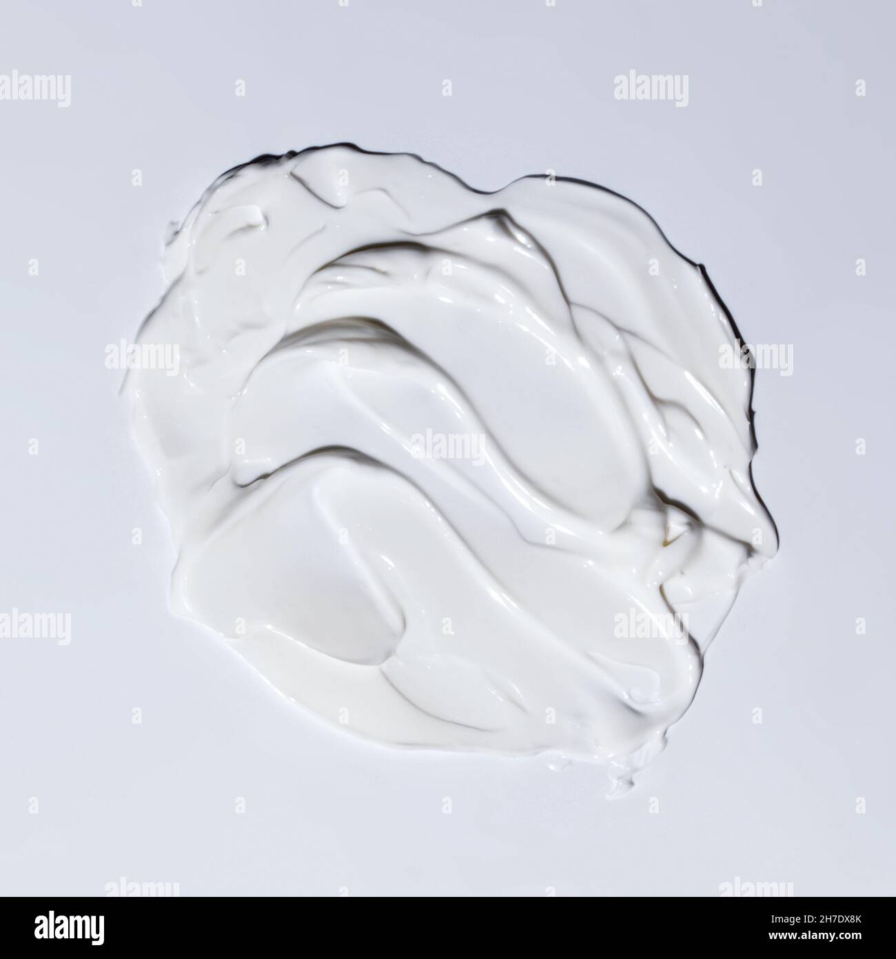 Sample of white cosmetic cream, drops of gel and foam on a gray ...