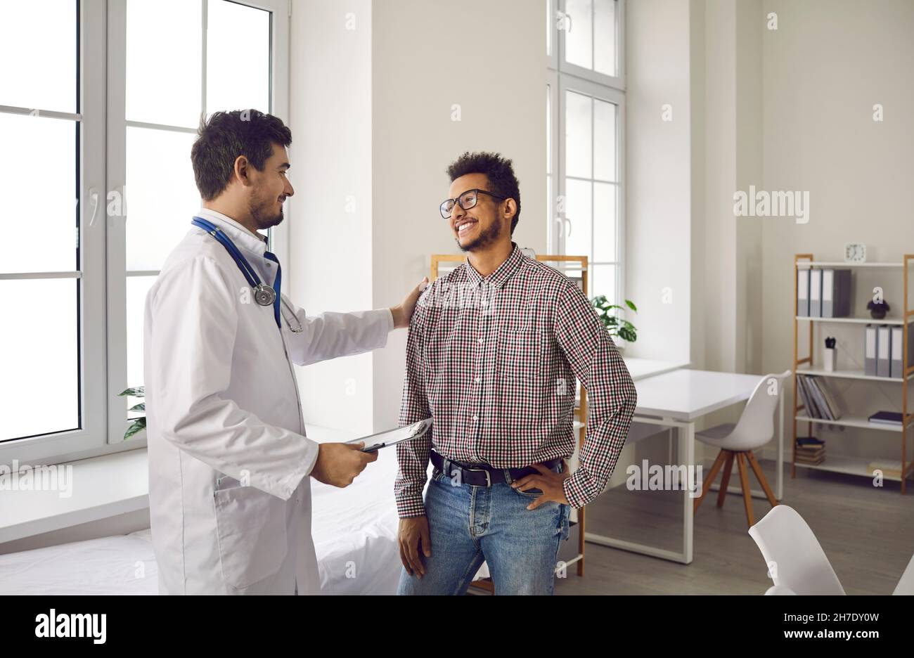 Doctor reassuring his patient after a consultation and health checkup ...