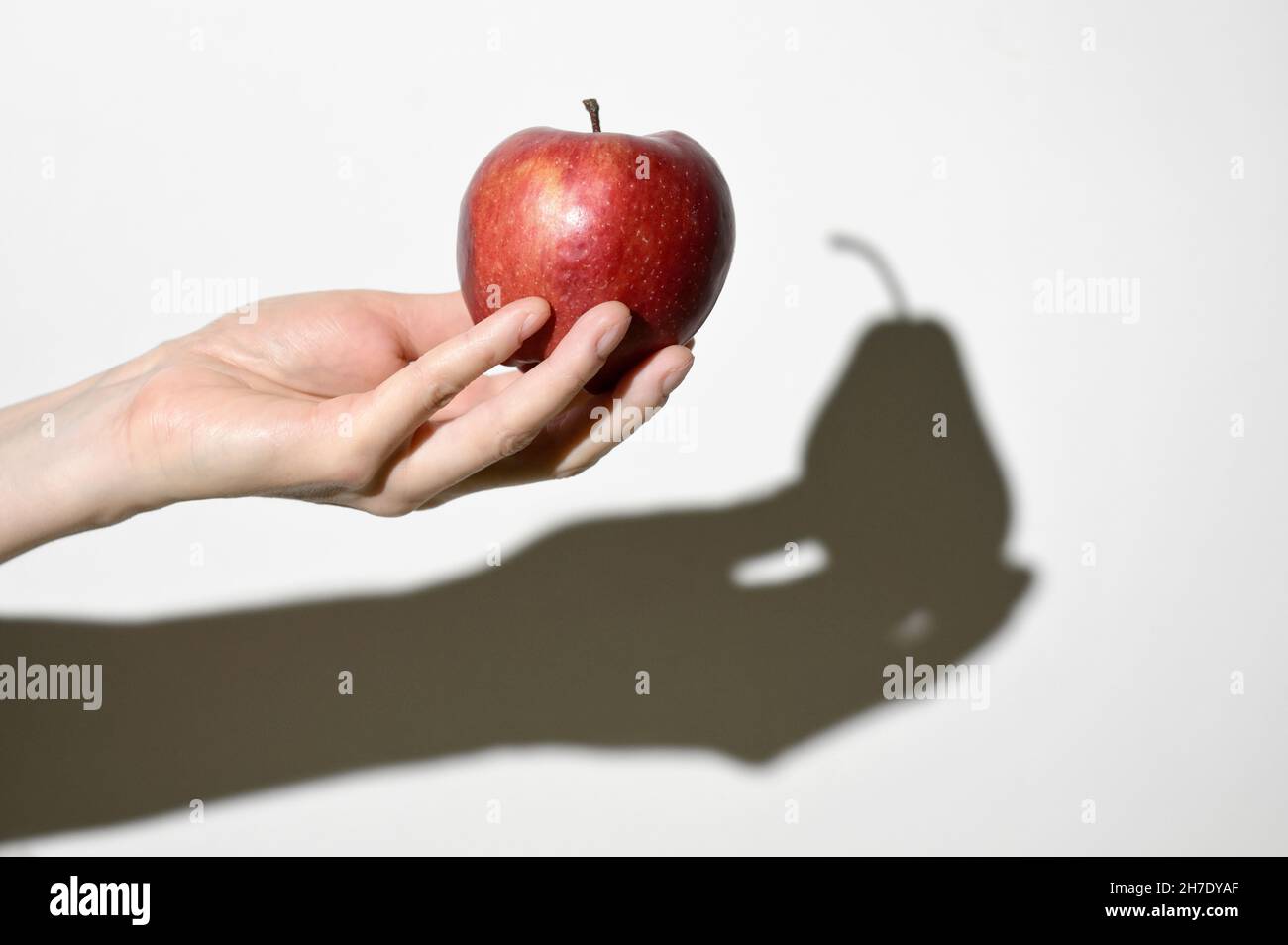 Visual Dissonance Concept. Apple Fruit and Pear Fruit Shadow Stock ...