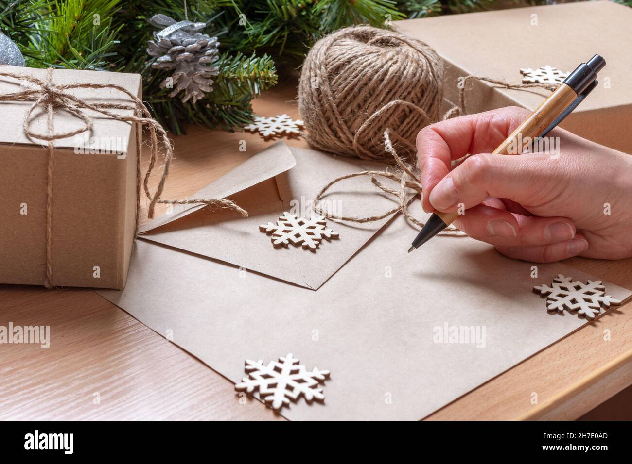 Gift List - Hand holding a pen over a blank sheet of paper, gifts in ...