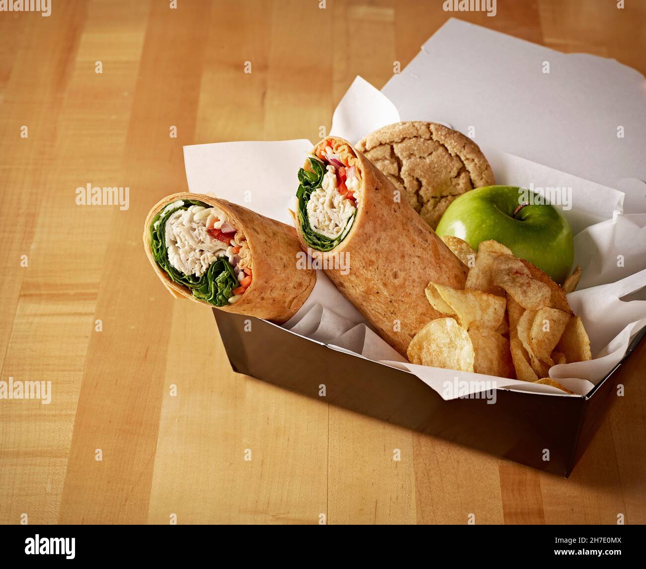 Turkey Wrap Box Lunch with Apple and Cookie Stock Photo - Alamy