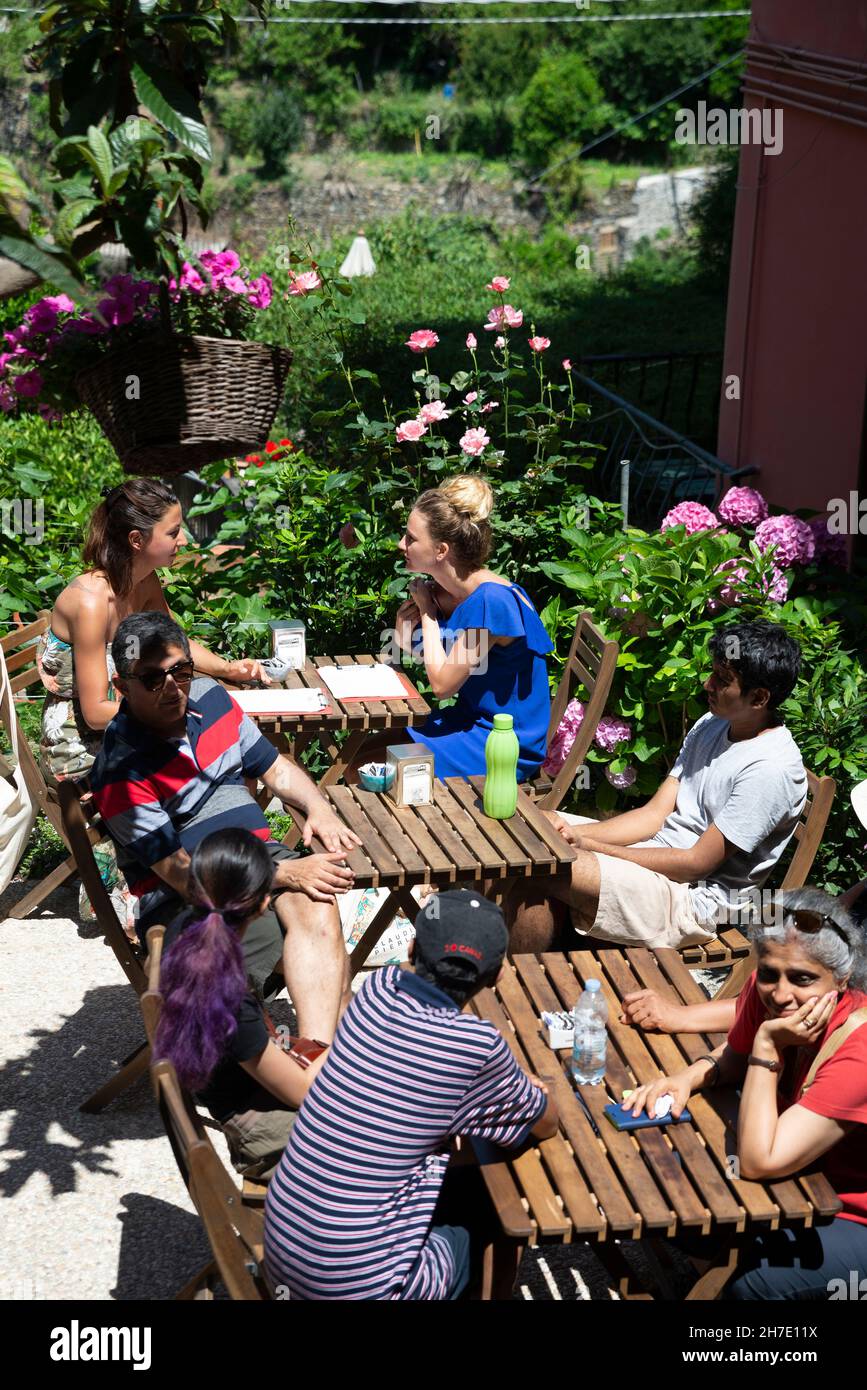 People eating outside in a restaurant in Corniglia, Cinque Terre, Italy ...