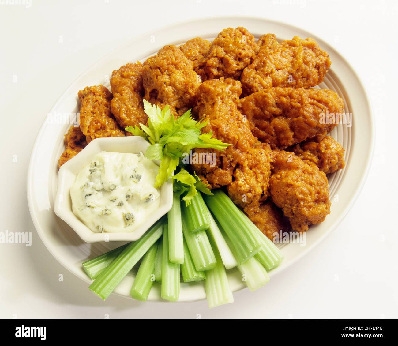 Buffalo chicken wings with celery and a blue cheese dip Stock Photo - Alamy