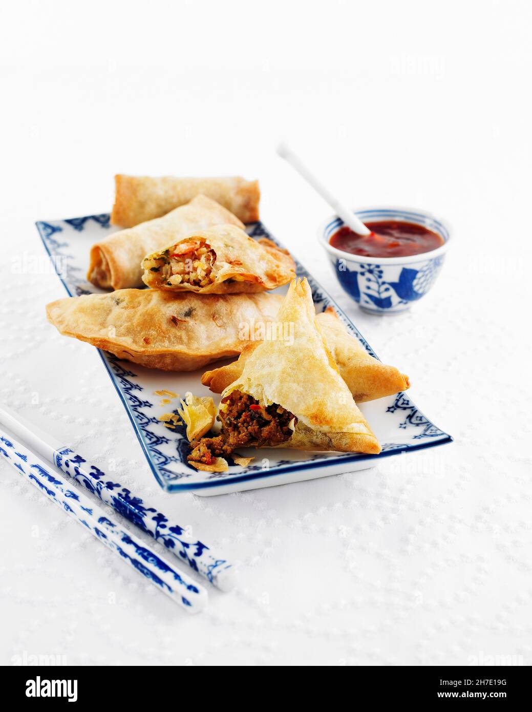 Various spring rolls and samosas with a dip (Asia Stock Photo - Alamy