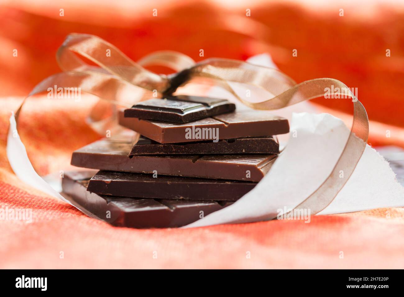 A stack of chocolate on paper as a gift Stock Photo - Alamy