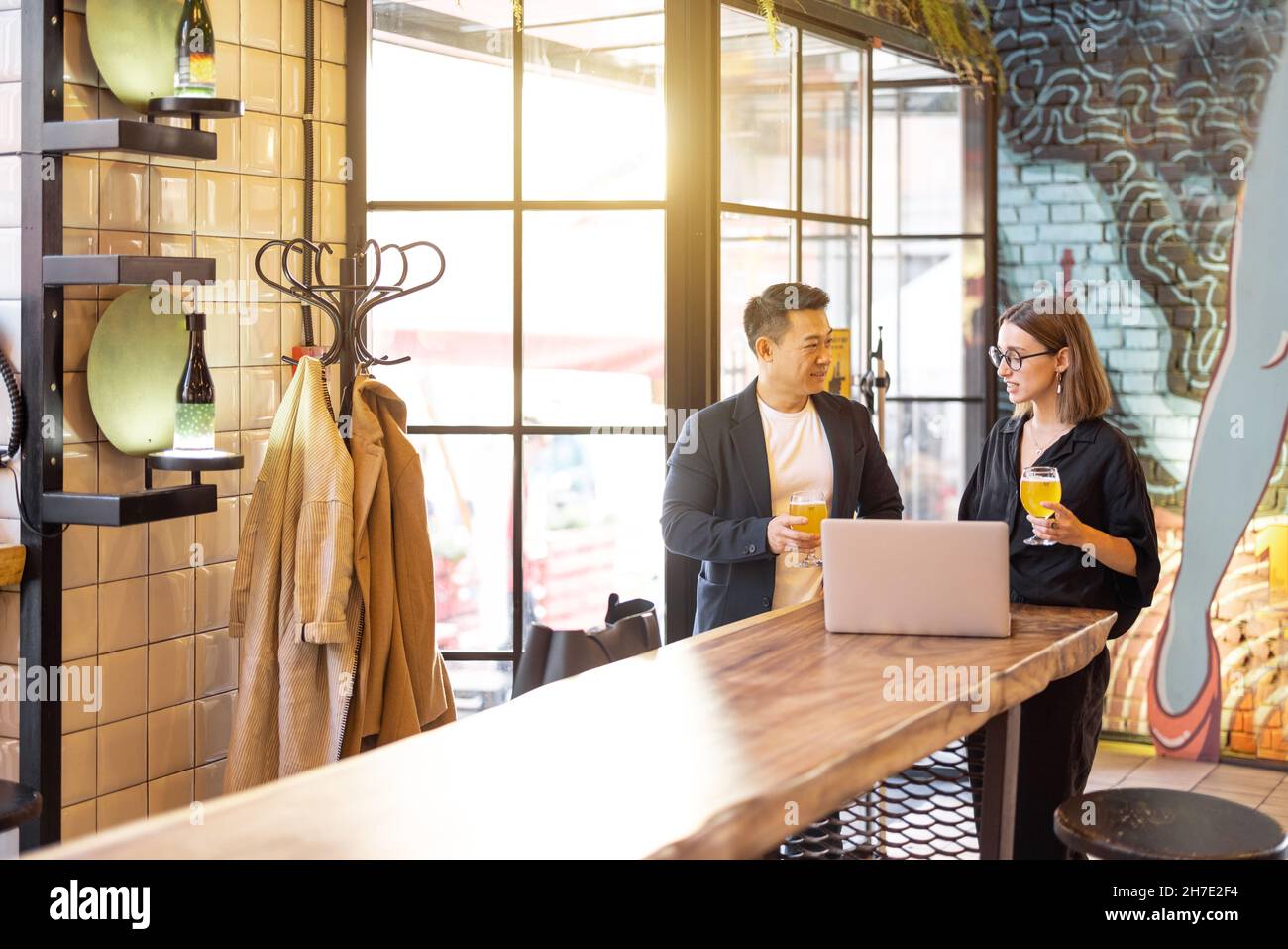 Friends talk and drink beer in bar Stock Photo - Alamy