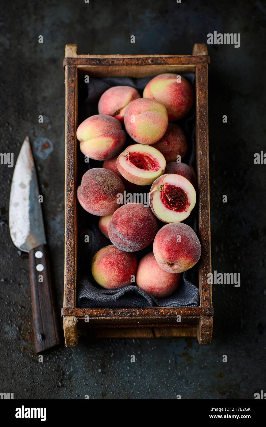 Fresh small peaches in a wooden box Stock Photo - Alamy