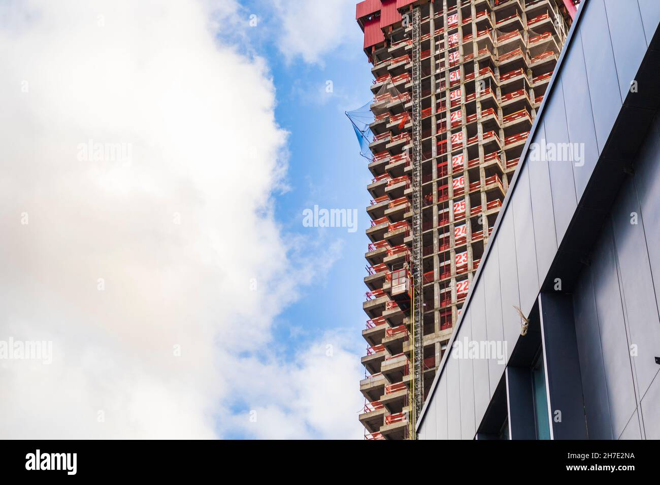 construction of skyscraper tower crane lifting of concrete plinths ...