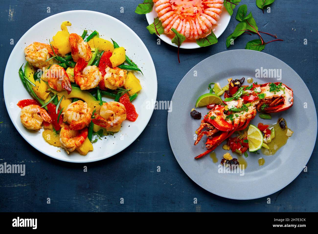 Three crustacean dishes: prawns with fruit, a ring of prawns amd ...