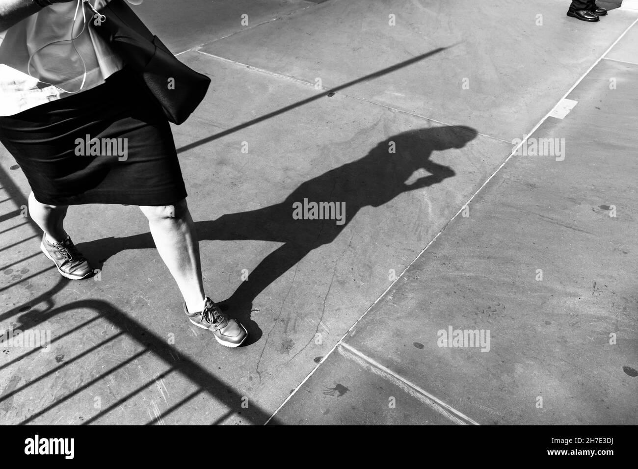 Light and shadows in New York City. Shadows of people walking street in ...