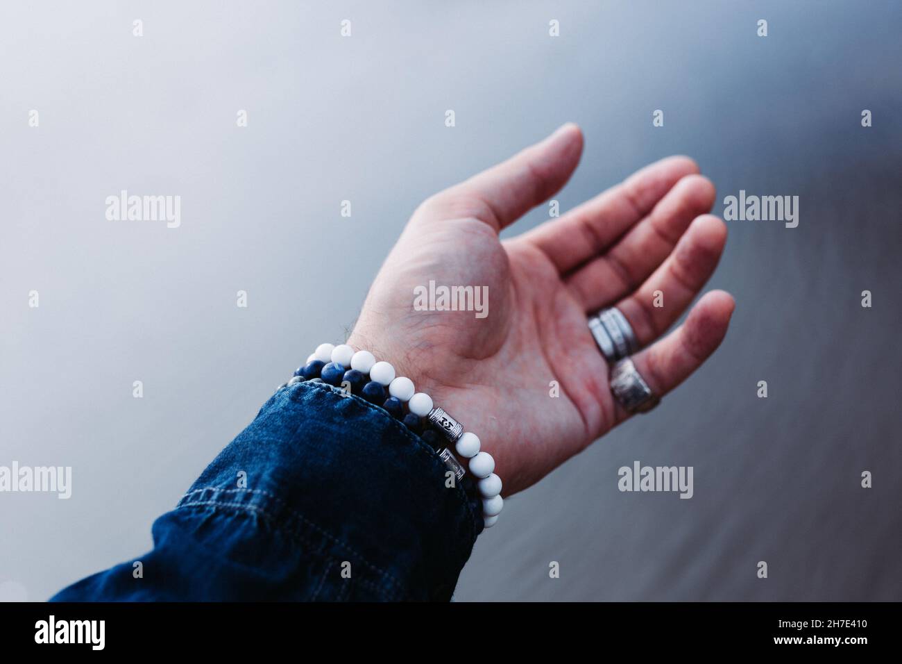 Open palm of a male wearing bracelets and rings Stock Photo - Alamy