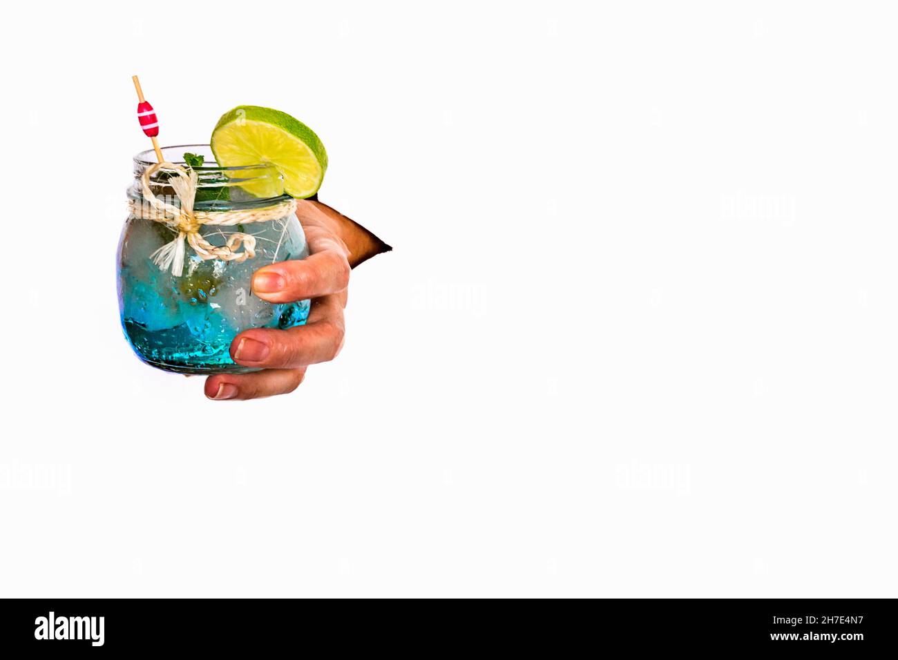 A hand holding a gin and tonic in a preserving jar Stock Photo - Alamy