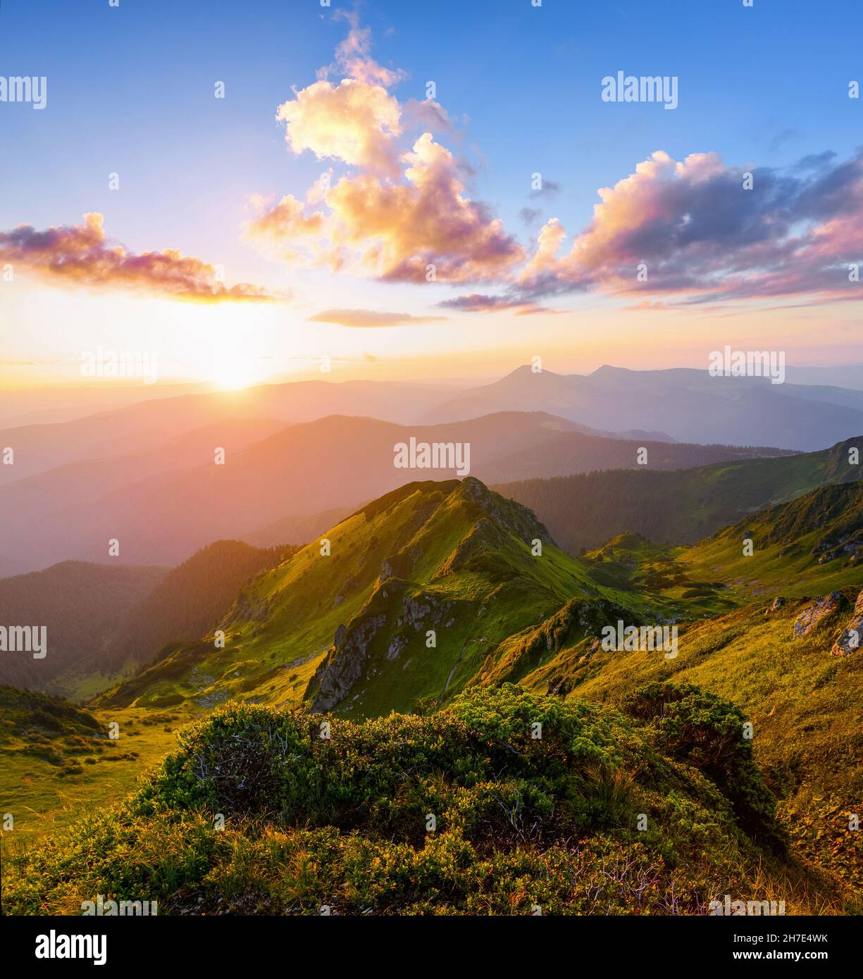 Mountain landscape with beautiful sunrise, cloudy sky and orange ...