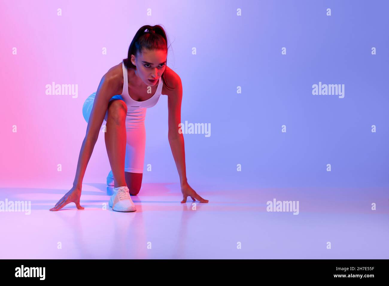 Athletic Female Doing Crouch Start Ready For Race, Neon Background ...