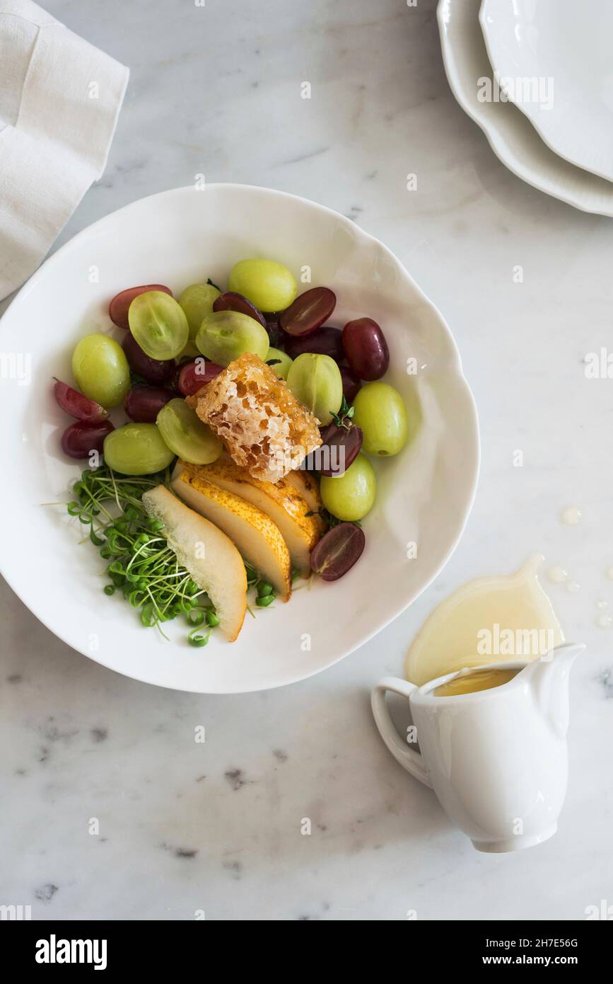 Pear and grape salad with honey and cress Stock Photo - Alamy