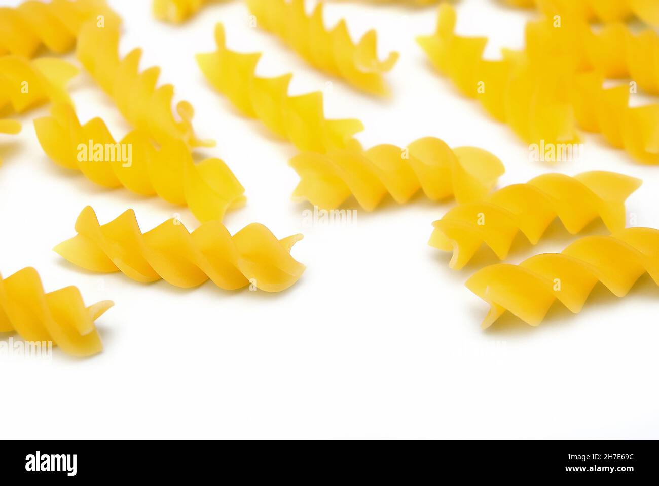 Fusilli Italian pasta spread on a white background Stock Photo - Alamy