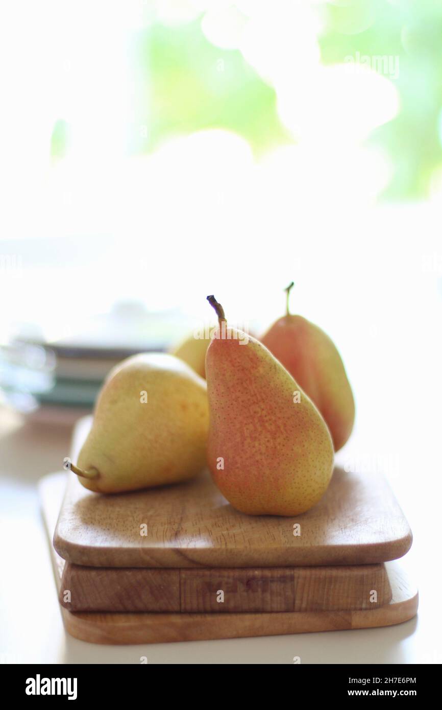 Four pears on a wooden board Stock Photo - Alamy
