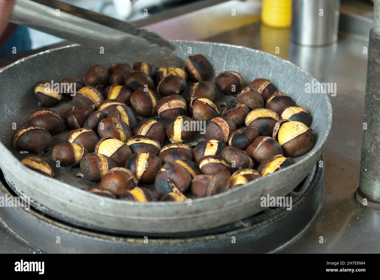 Street vendor roasting chestnuts Stock Photo - Alamy