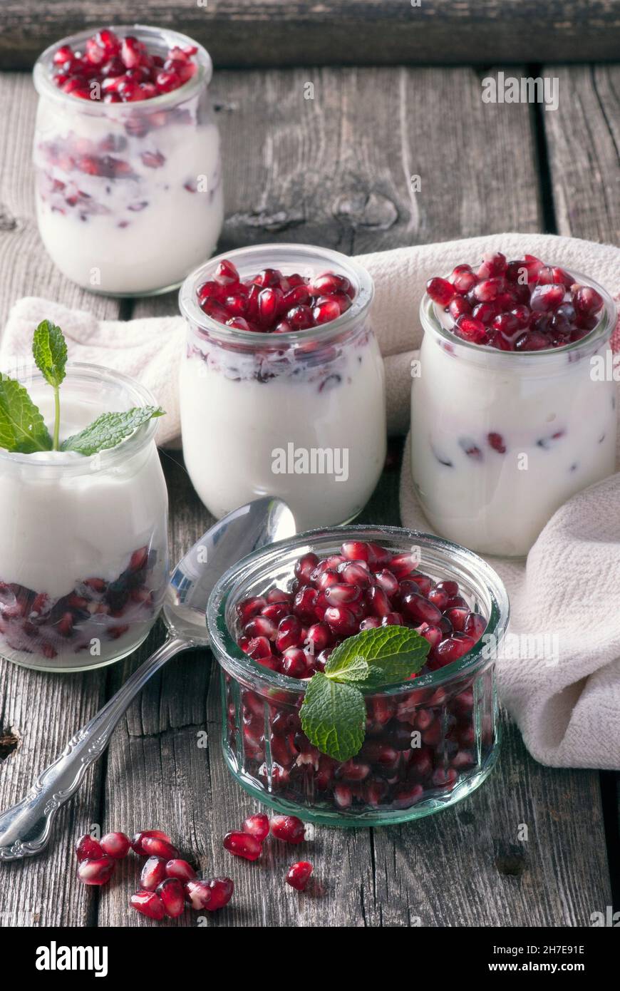 Mini yogurt with pomegranate seeds Stock Photo - Alamy