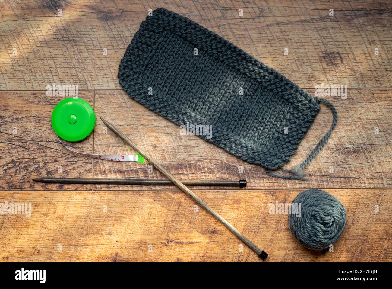 Blue yarn knitted swatch, wooden background testing a wool with knitted ...