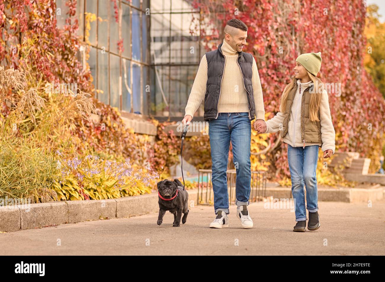 A family going for a walk with a dog Stock Photo - Alamy