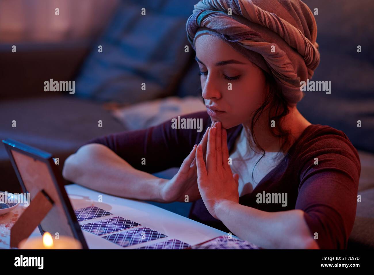 Fortune-teller praying before a Tarot card reading ritual Stock Photo ...