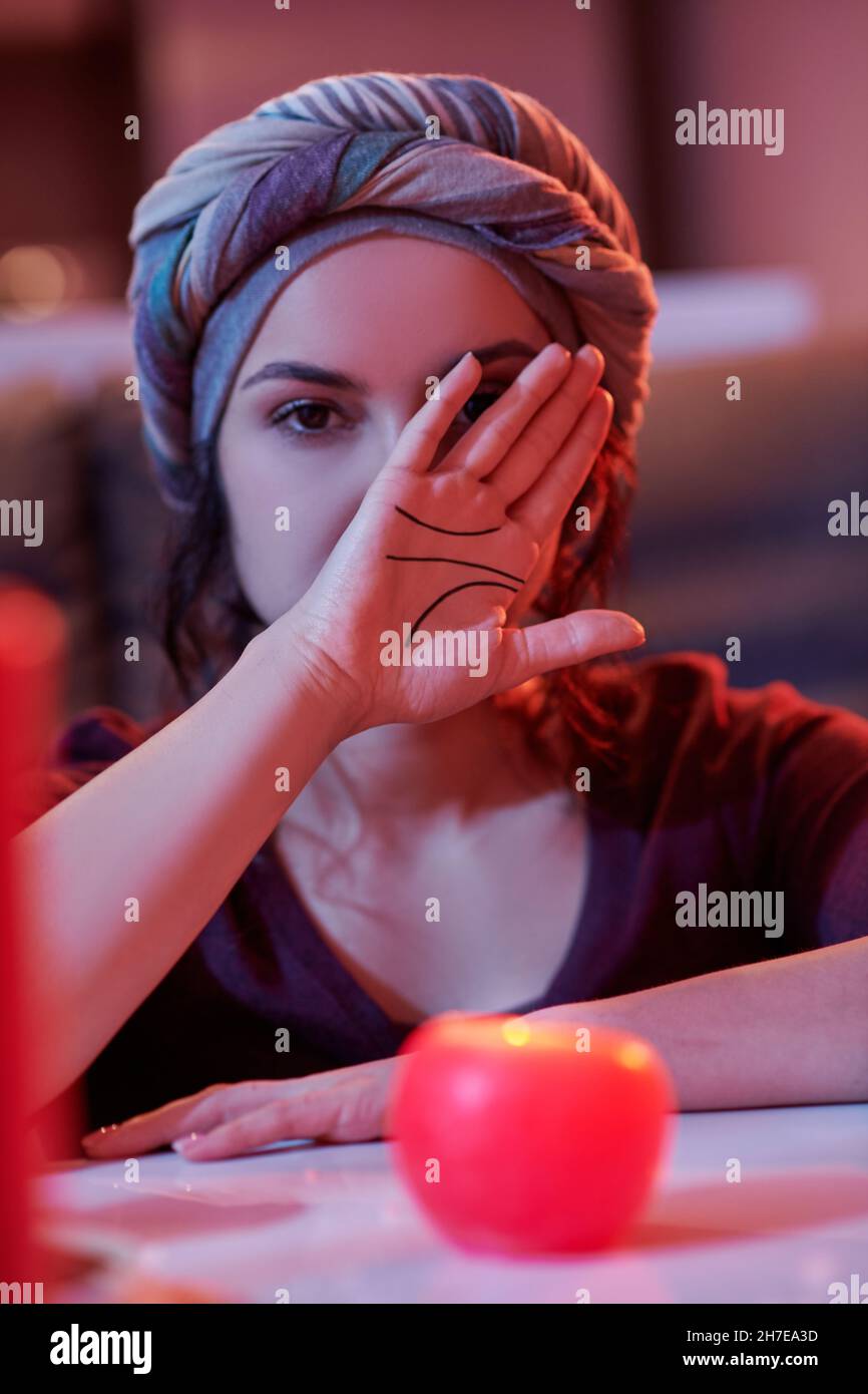 Chiromancer demonstrating her hand with palmar creases Stock Photo - Alamy