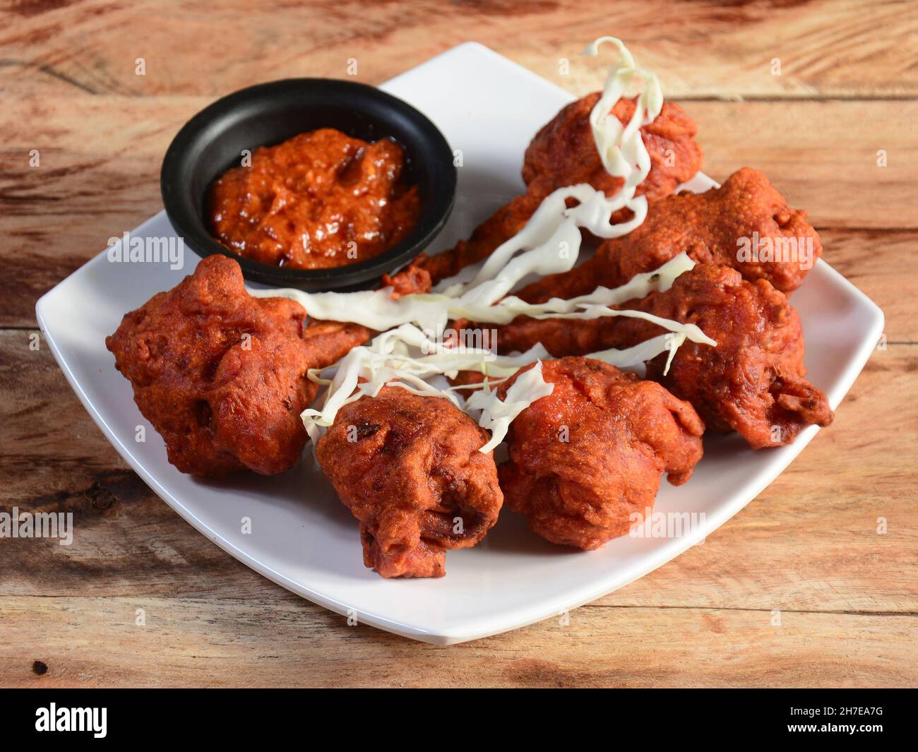 Chicken lollipop is Indian Chinese appetizer served over a wooden ...