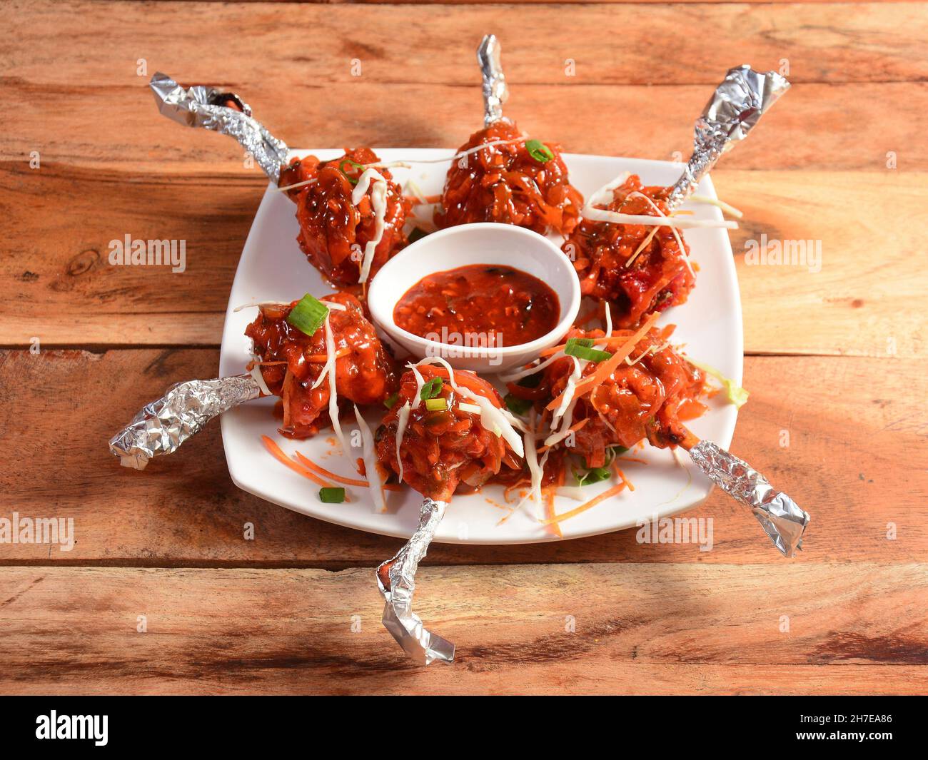 Chicken lollipop schezwan is an Indian Chinese appetizer served over a ...