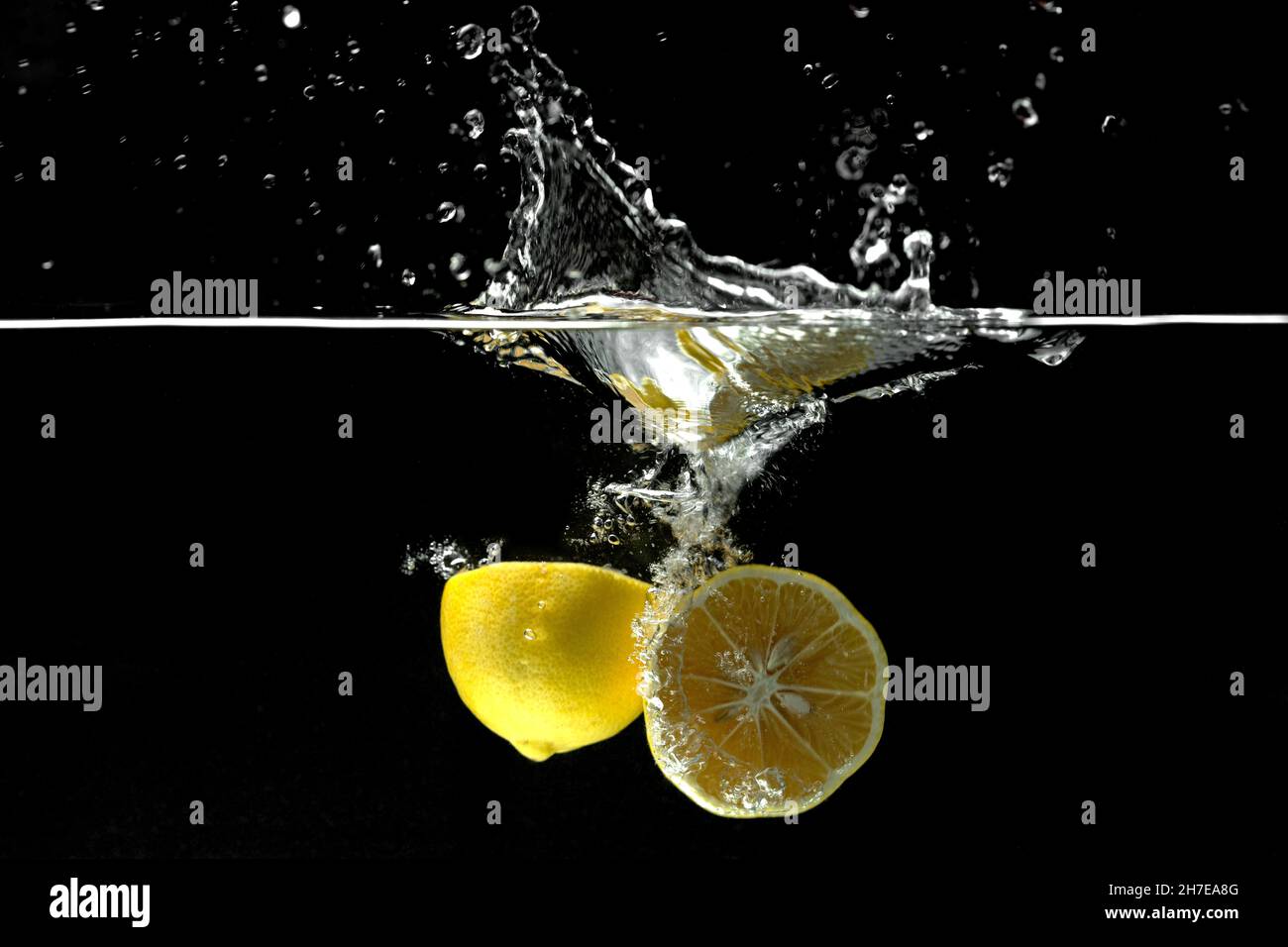 Lemon falling into water creating movement, motion and splashes Stock Photo - Alamy