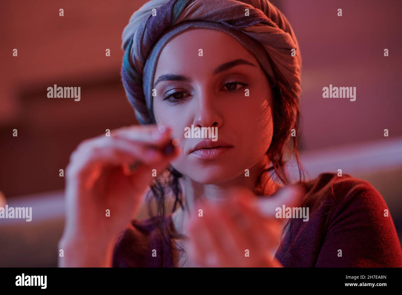 Fortune-teller in headwear staring at a healing crystal Stock Photo - Alamy