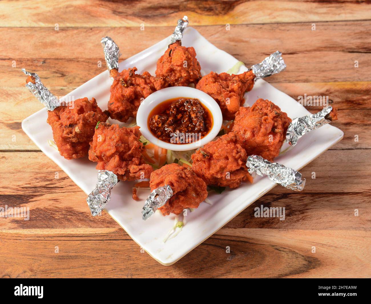 Chicken lollipop is Indian Chinese appetizer served over a wooden ...