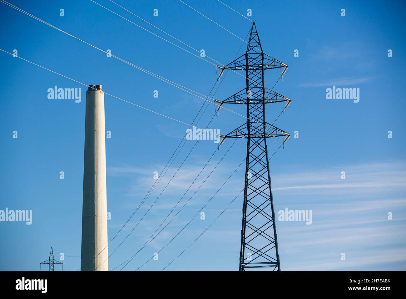 electrical distribution tower with thermal power station chimney next ...