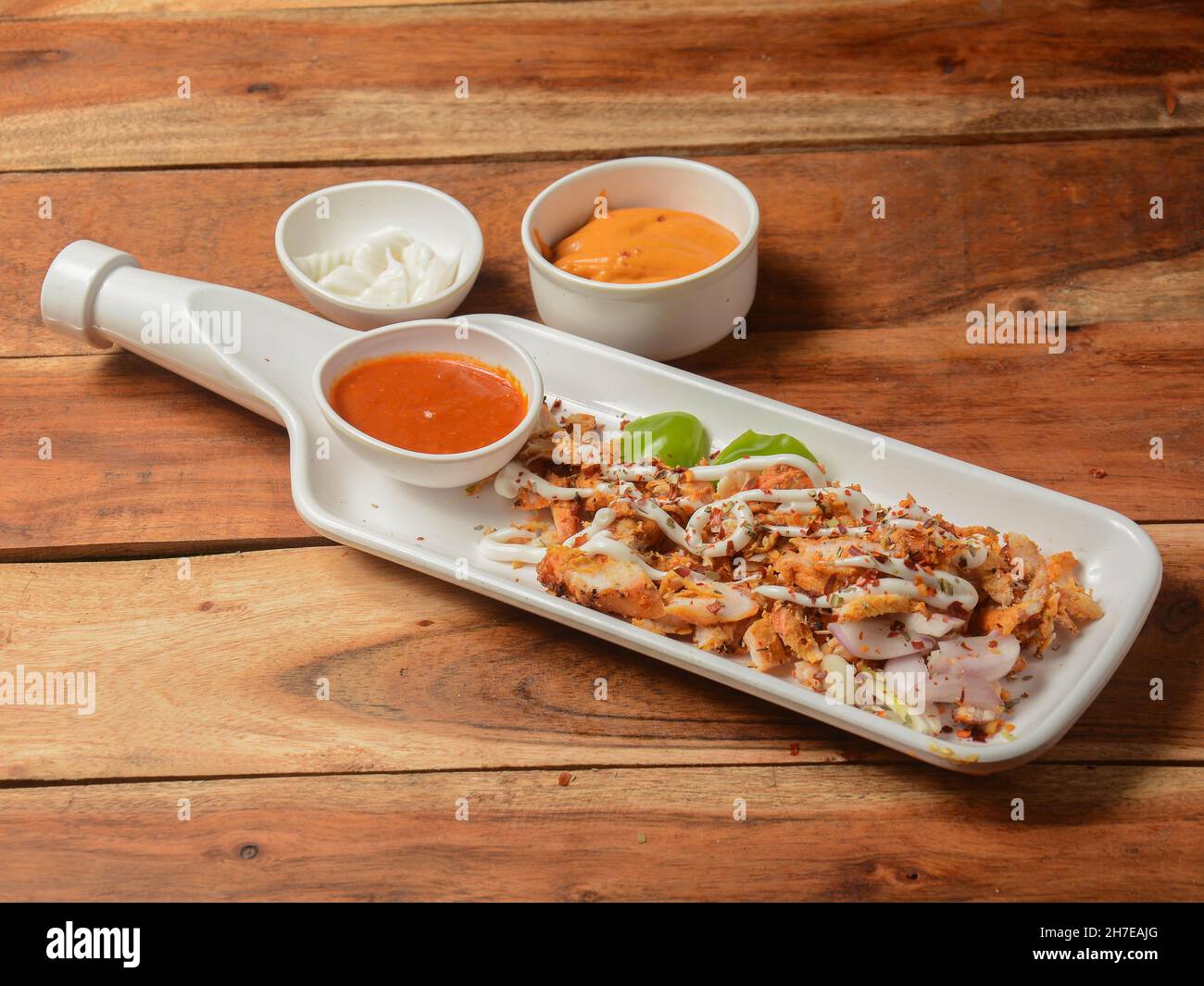Chicken shawarma platter served on rustic wooden background. Dishes and ...