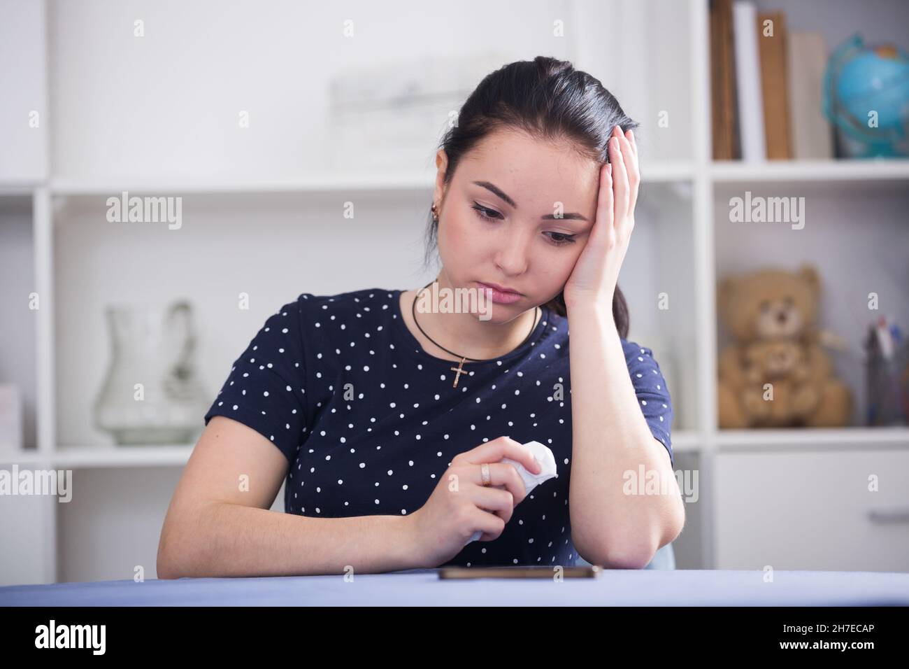 Sad girl waiting for phone call Stock Photo - Alamy
