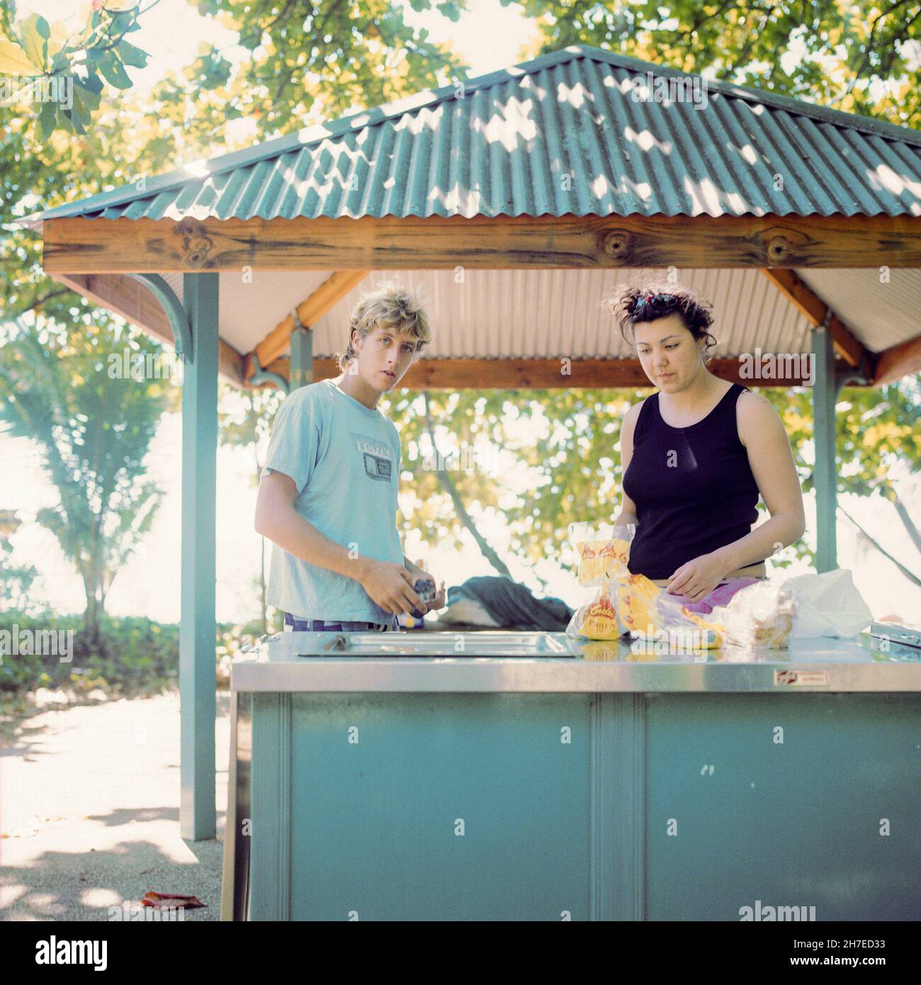 Cooking at a public beach side electric barbecue, Cairns, Australia ...
