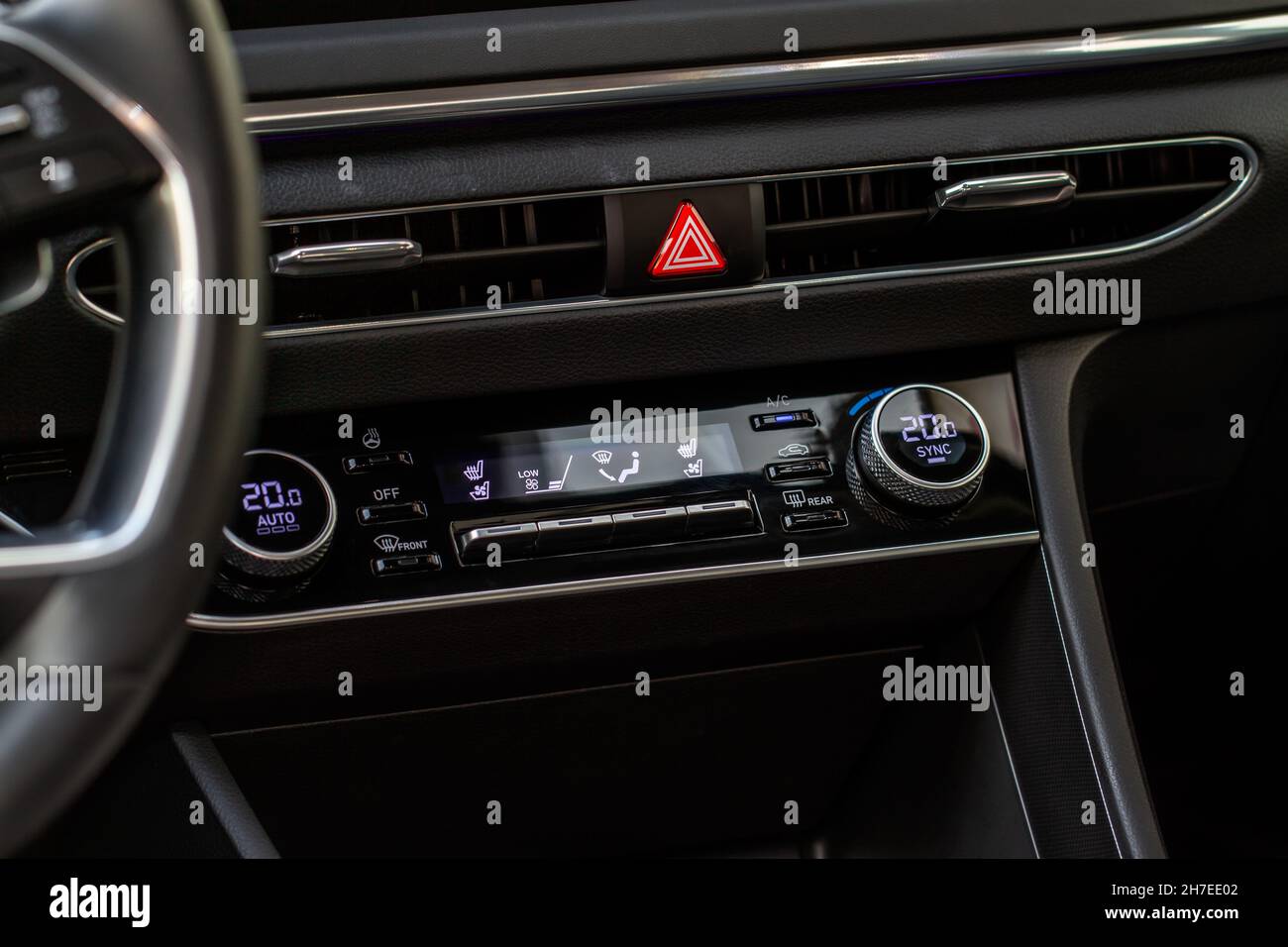 Red triangle hazard light button on car dashboard. Car media buttons ...