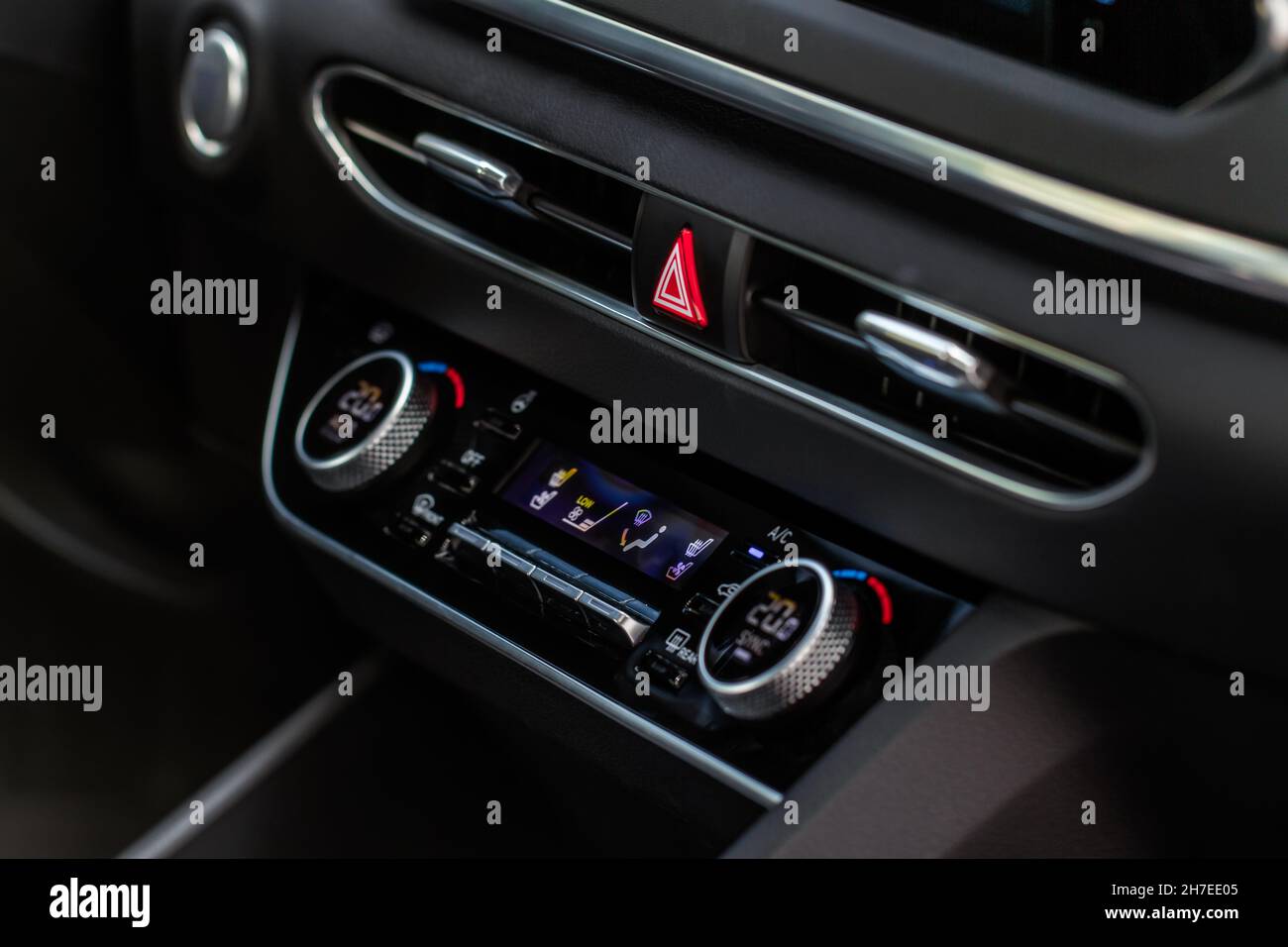 Red triangle hazard light button on car dashboard. Car media buttons ...