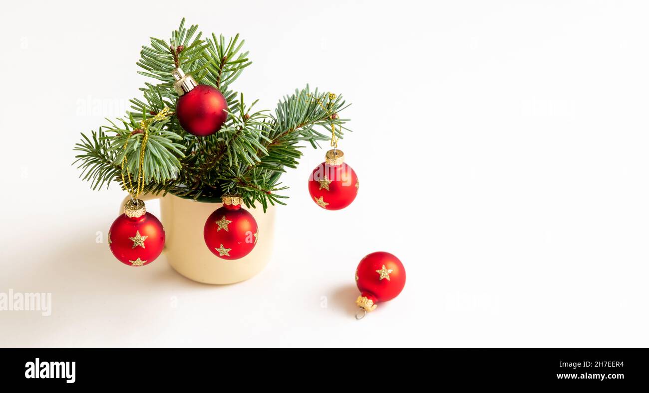 Christmas fresh fir twigs and red baubles decoration in an enamel ...