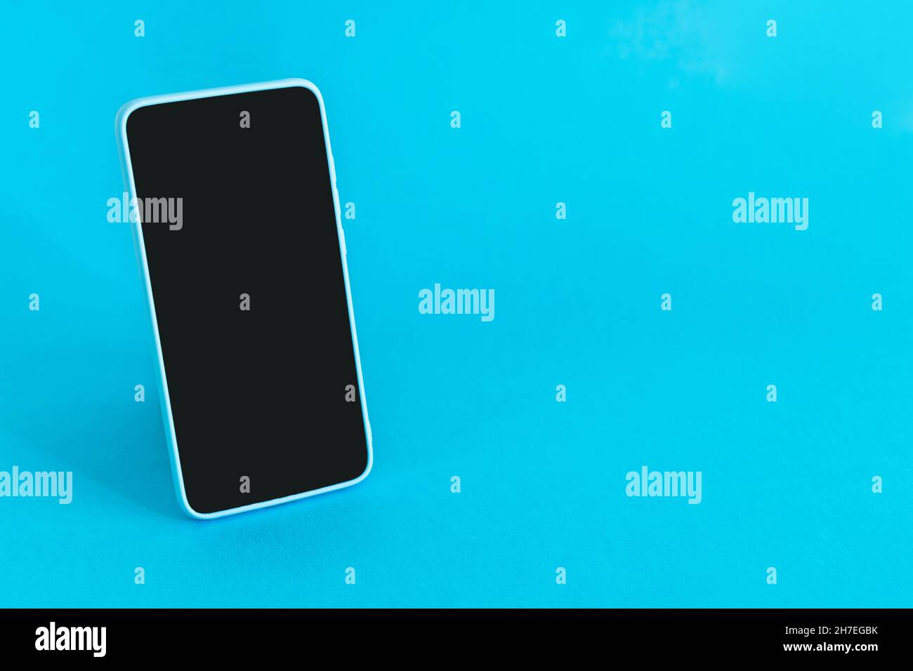 Smartphone with a blank black touch screen on the blue background with ...