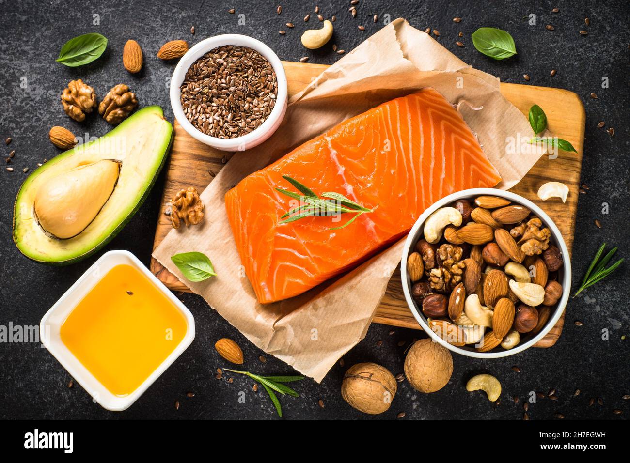 Healthy fats products at black background Stock Photo - Alamy