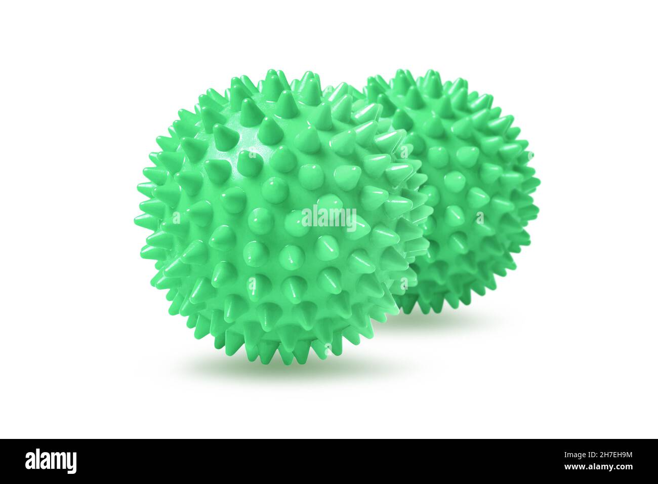Two green spiny massage balls isolated on white. Concept of ...