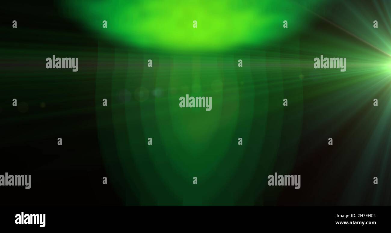 Image of glowing green form and refracted green light moving on black ...