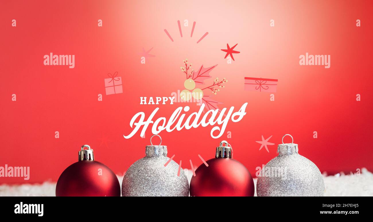 Image of happy holidays text over christmas baubles Stock Photo - Alamy
